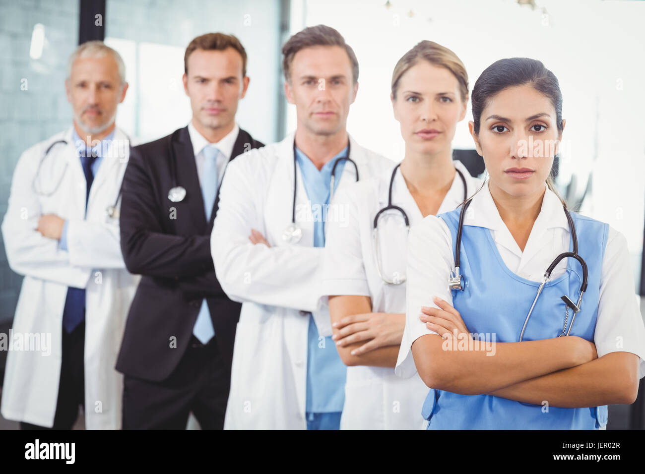 Medical team standing with arms crossed Stock Photo - Alamy