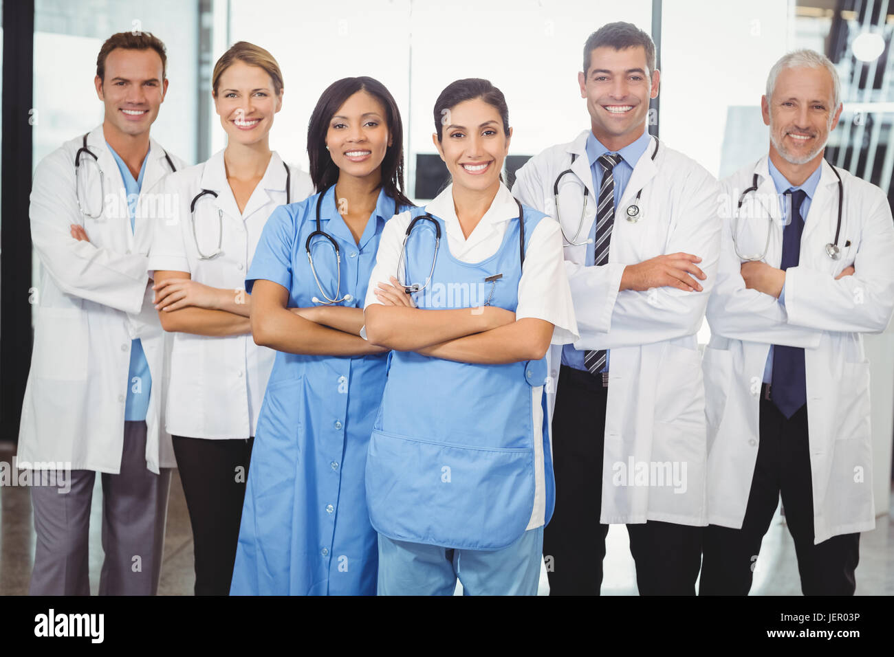 Medical team standing with arms crossed Stock Photo - Alamy
