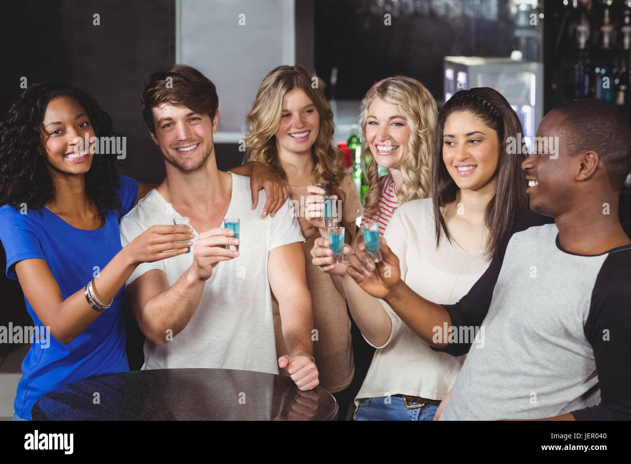 Group of friends having shots Stock Photo - Alamy