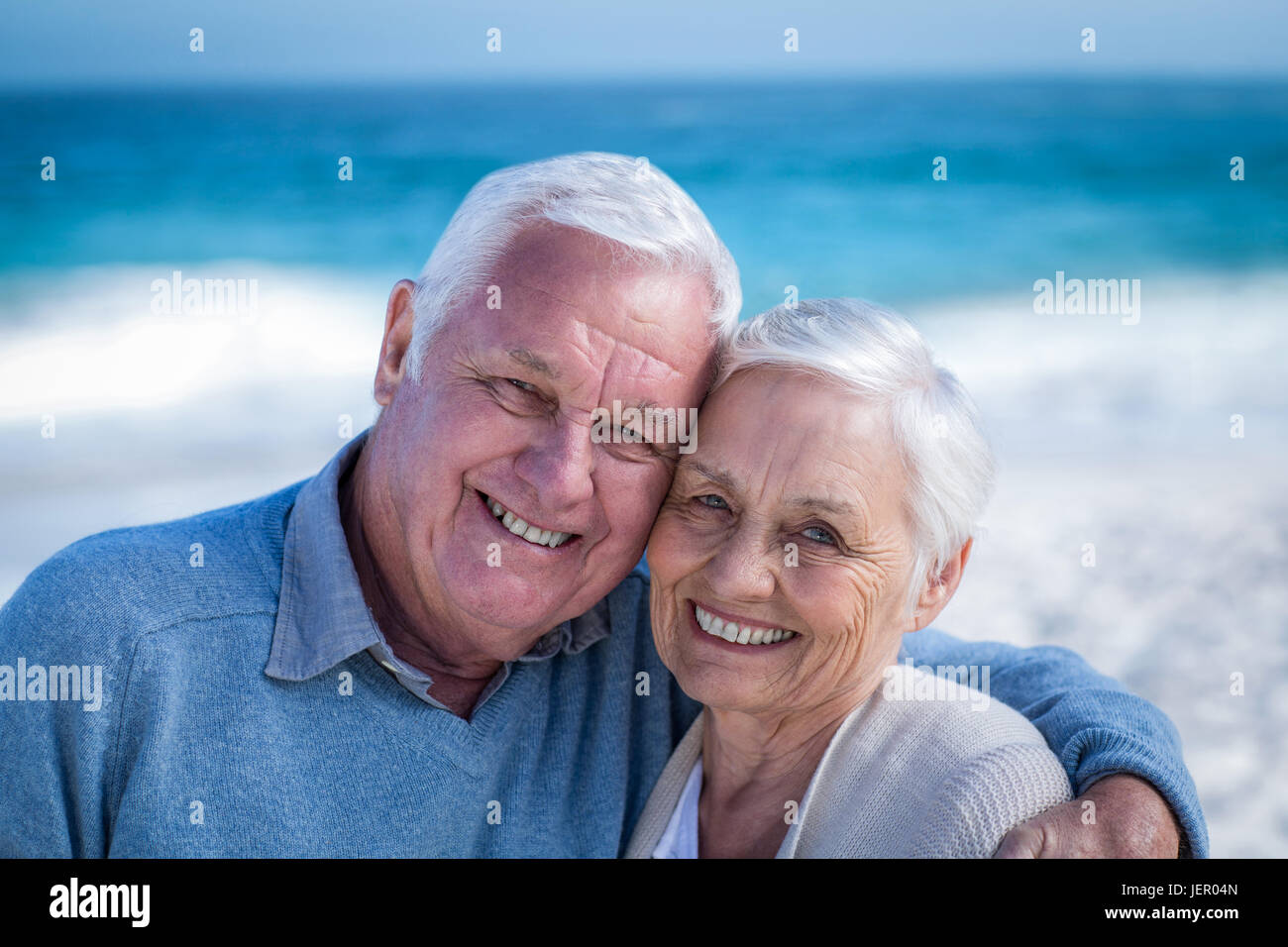 Cute mature couple embracing on the beach Stock Photo - Alamy