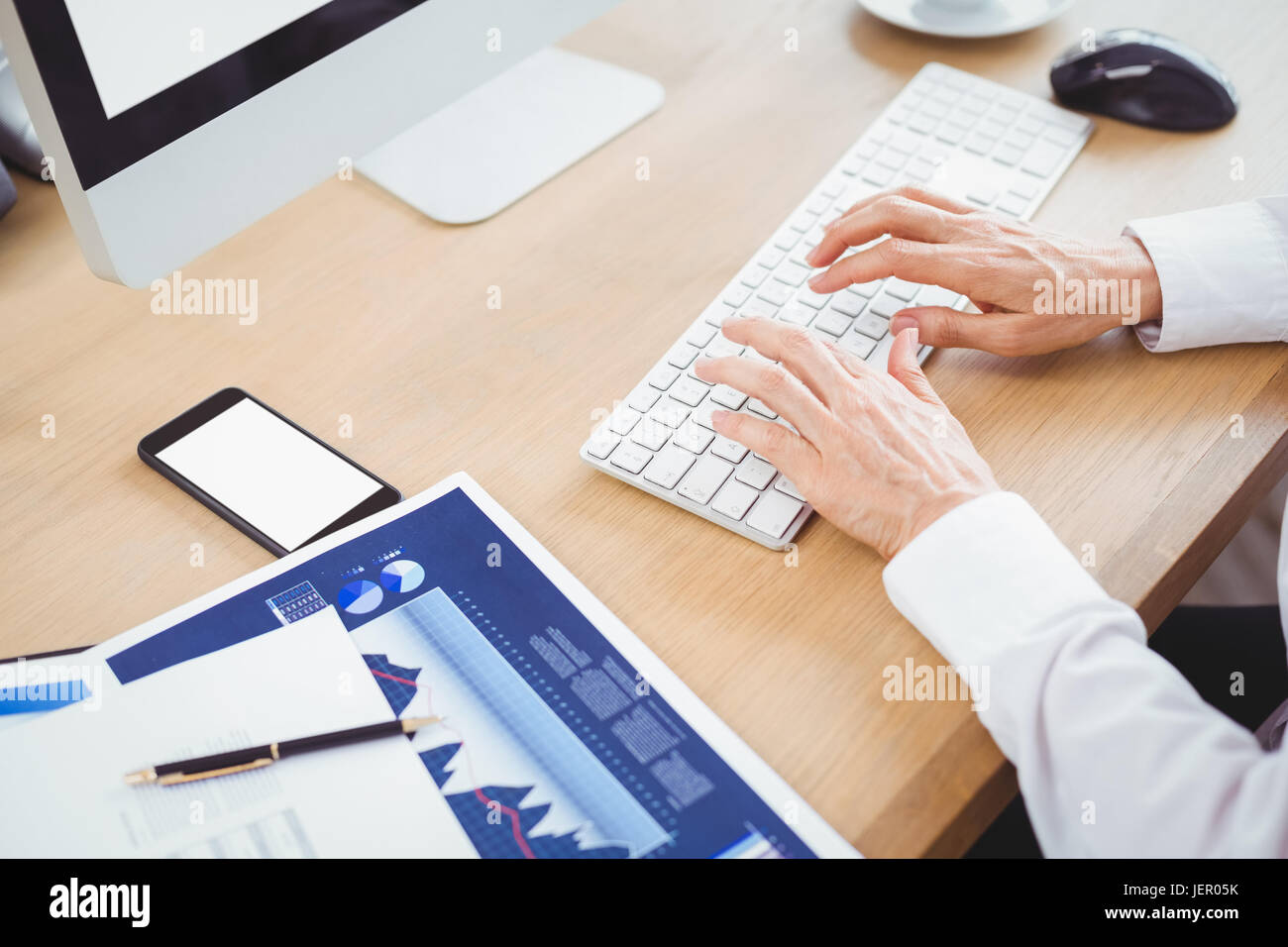 Businesswoman using computer at desk Stock Photo - Alamy