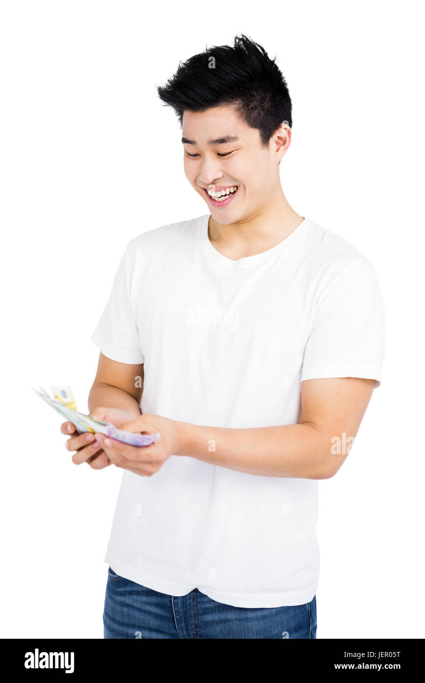 Young man counting currency notes Stock Photo - Alamy