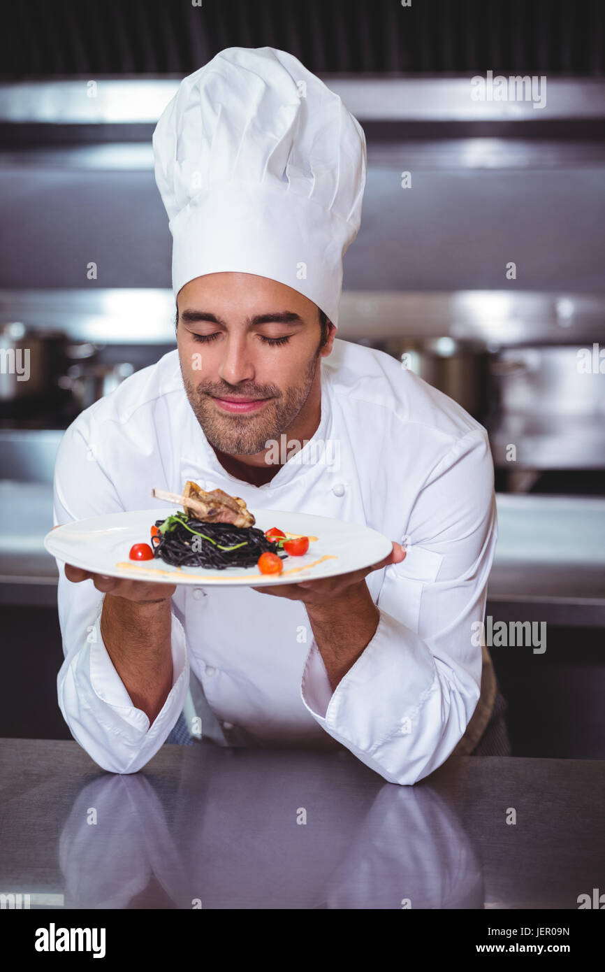 Male chef with eyes closed smelling food Stock Photo - Alamy