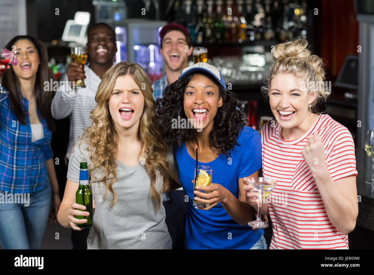 Happy friends watching sport Stock Photo - Alamy