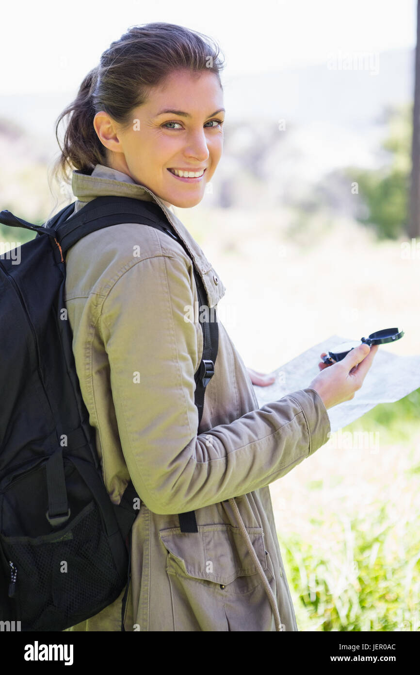 Woman with map and compass Stock Photo - Alamy