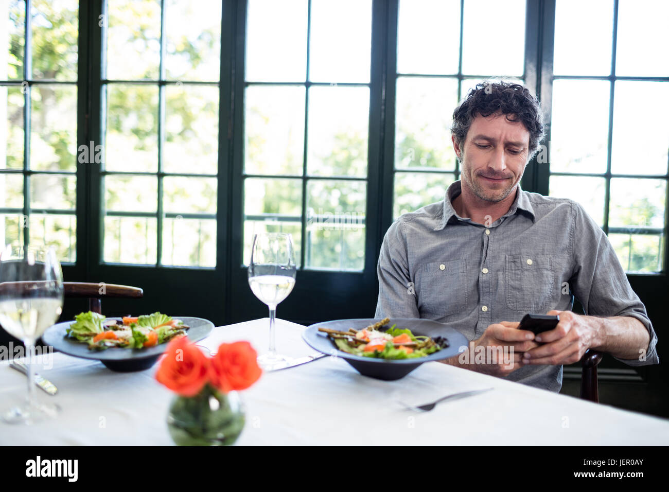 Man in a restaurant using mobile phone Stock Photo - Alamy