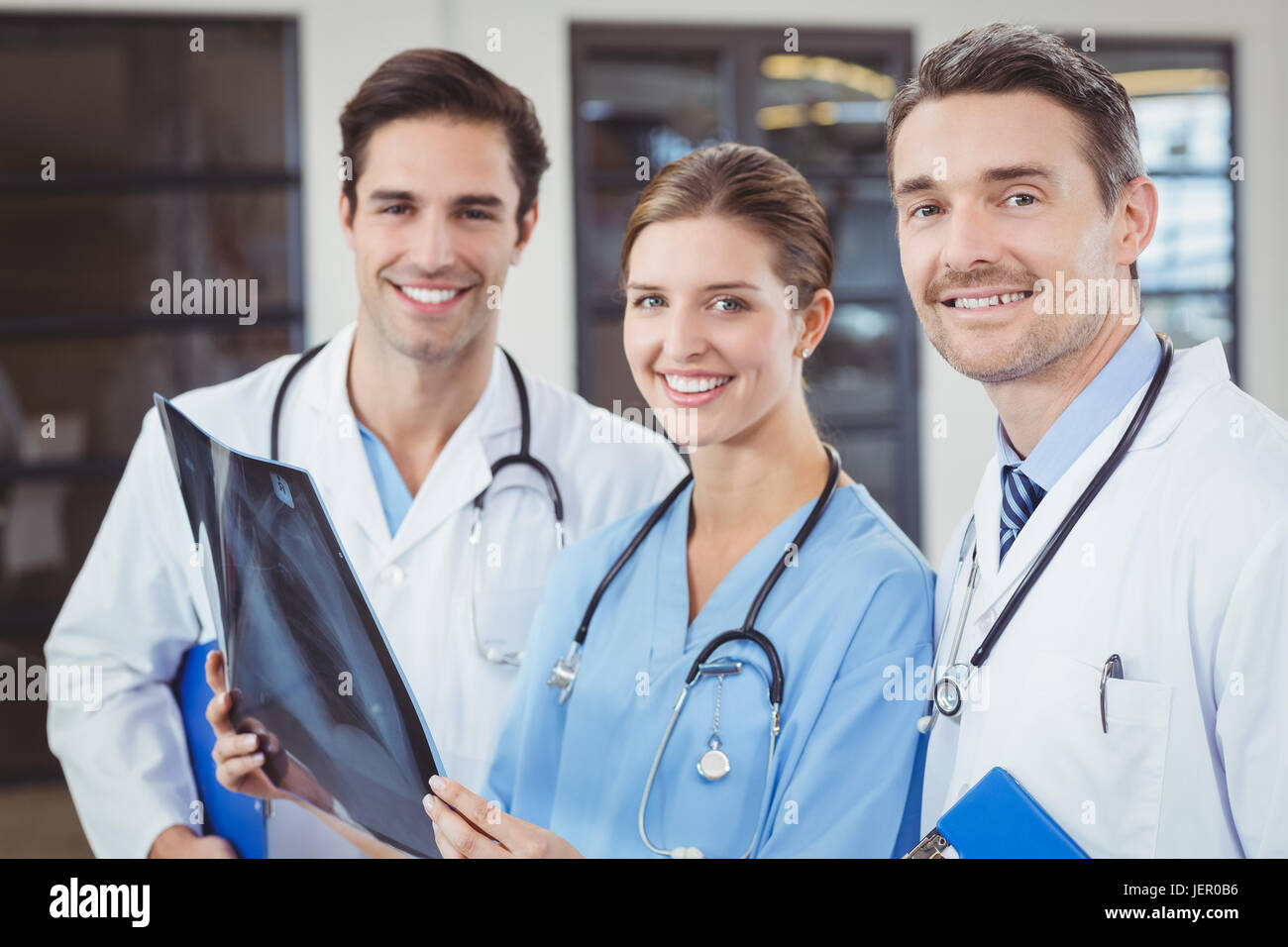 Portrait happy doctors holding hi-res stock photography and images - Alamy