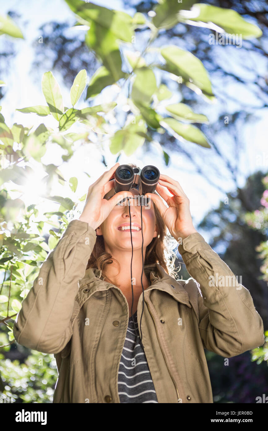 Woman using binoculars Stock Photo - Alamy
