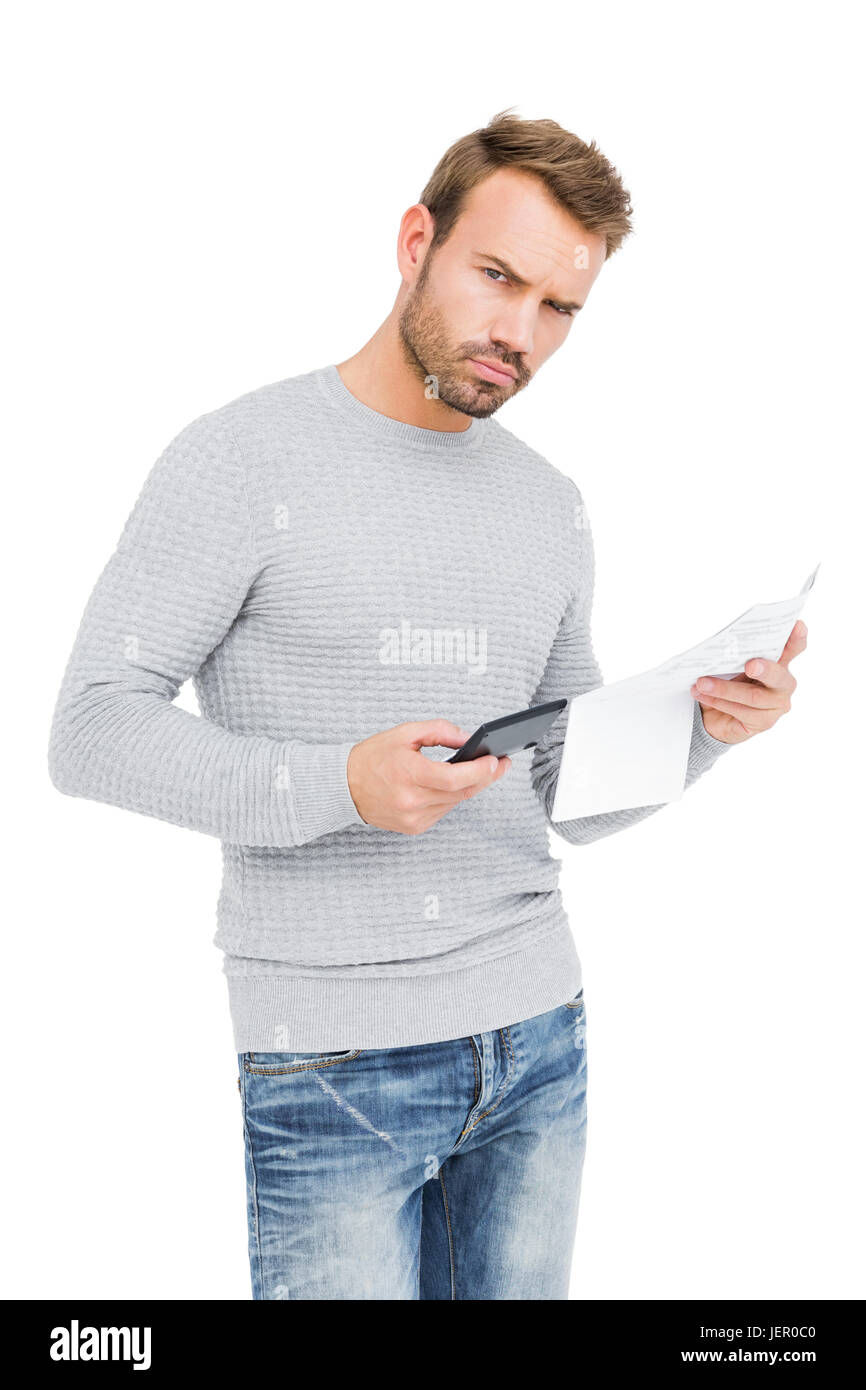 Young man calculating bill Stock Photo - Alamy