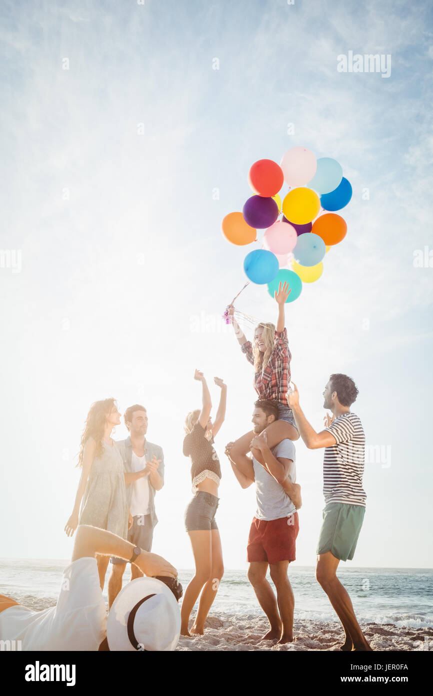 Portrait of friends holding balloon Stock Photo - Alamy