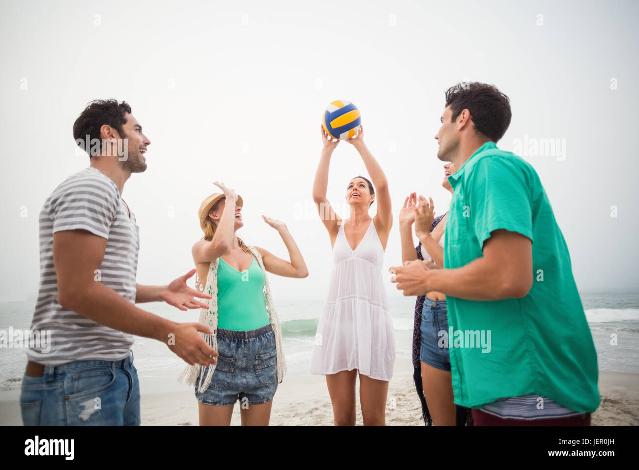 Group of friends playing with a beach ball Stock Photo - Alamy