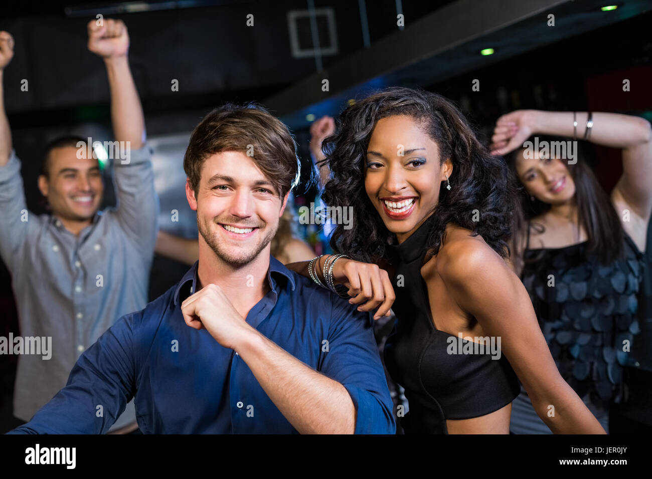 Happy friends dancing together Stock Photo - Alamy
