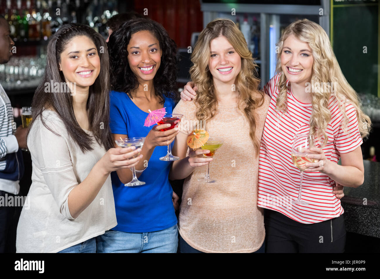 Friends drinking cocktails together Stock Photo - Alamy