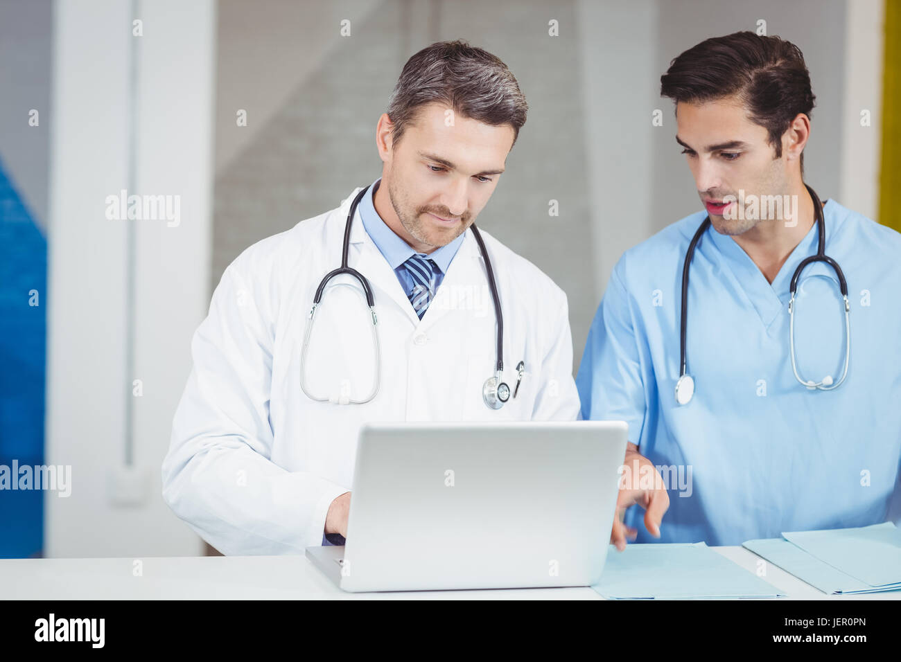 Concentrated doctors working on laptop Stock Photo - Alamy