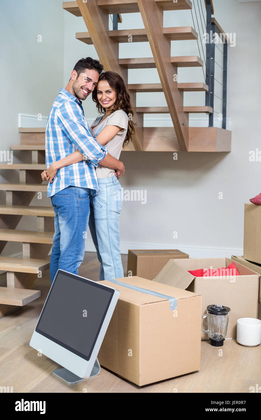 Portrait of cheerful couple hugging Stock Photo - Alamy