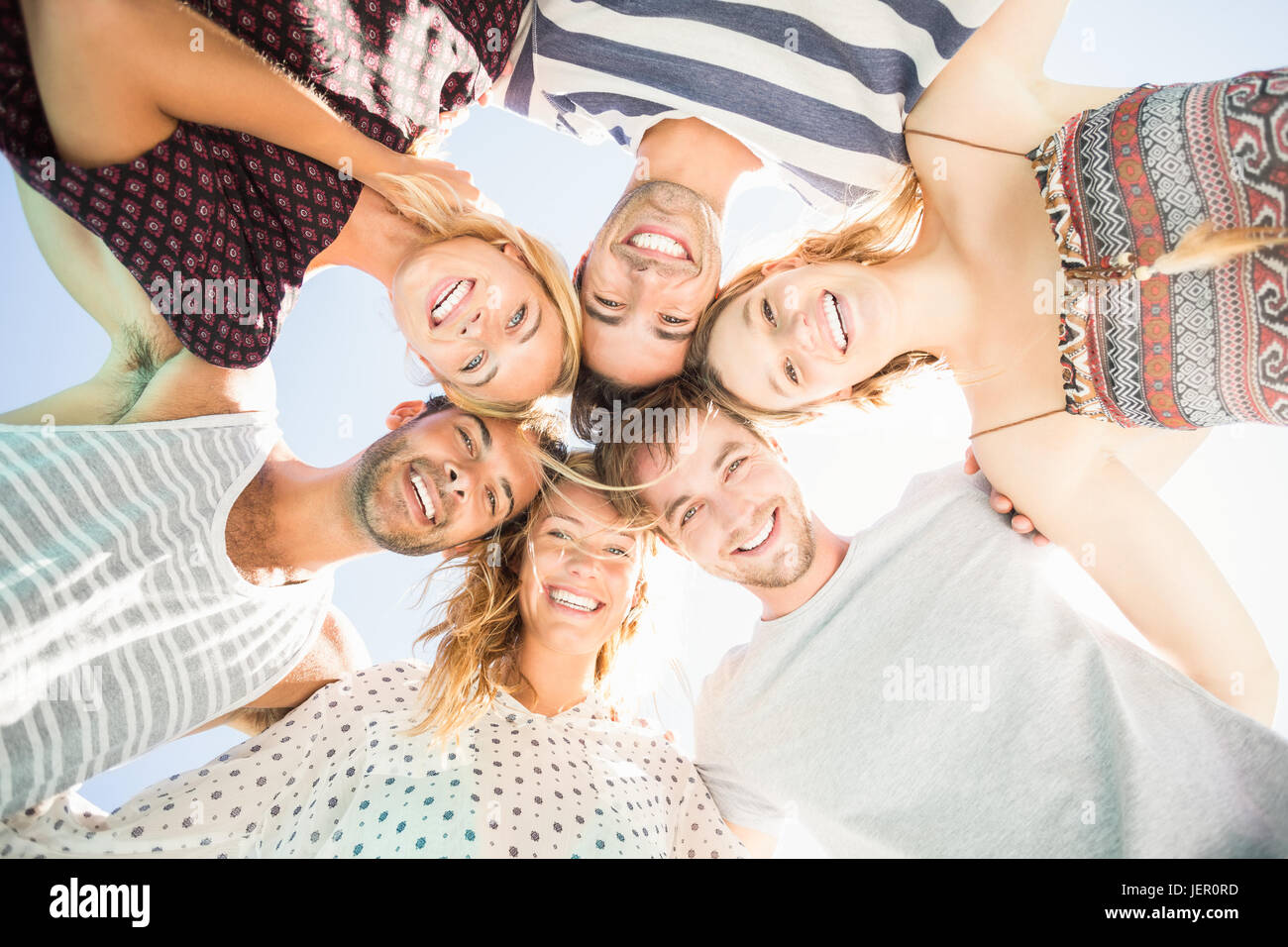Group of friends forming a huddle Stock Photo - Alamy