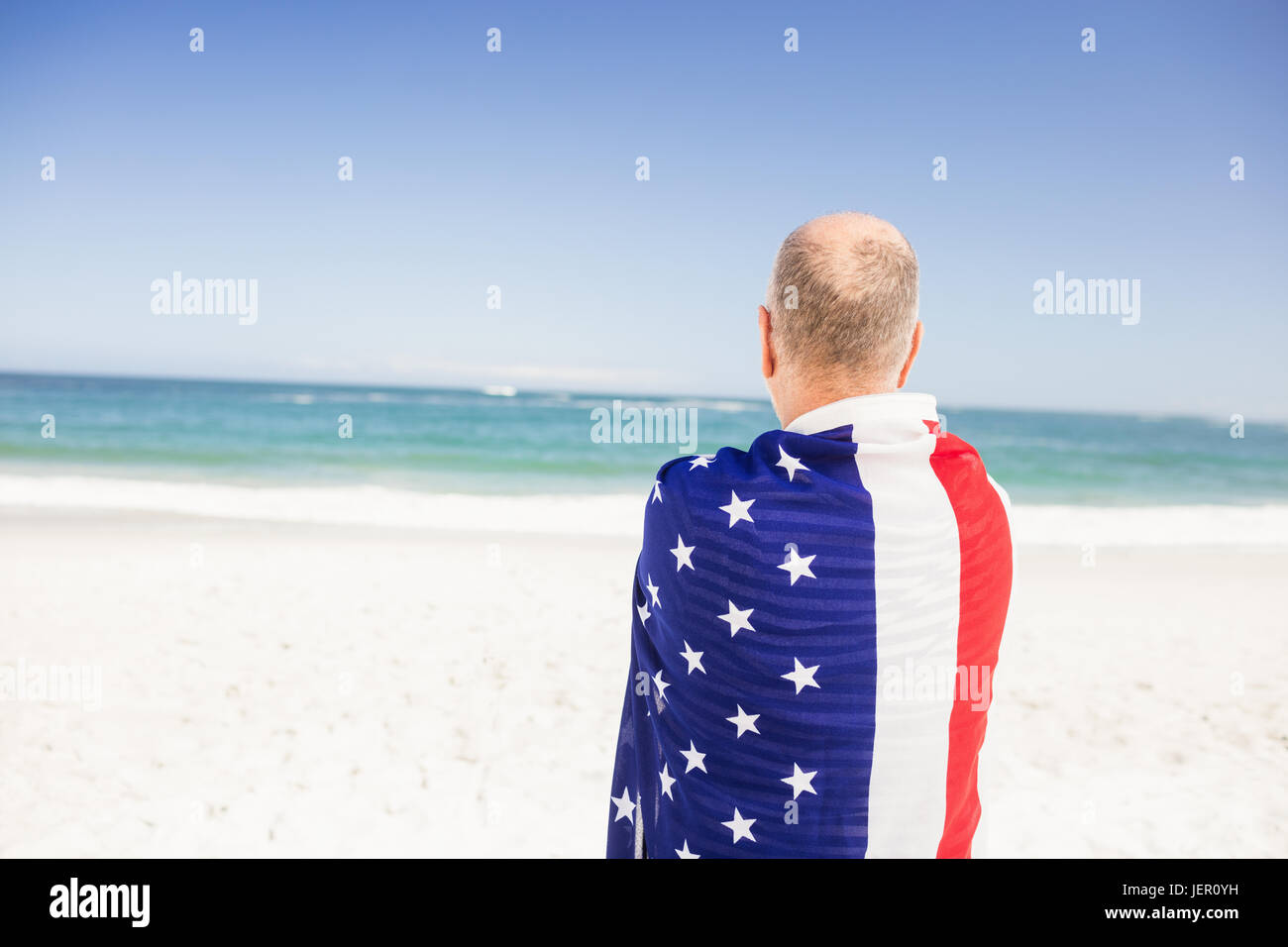 Senior man holding american flag Stock Photo - Alamy