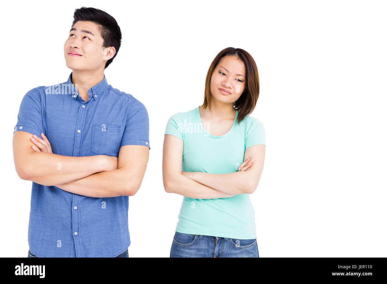 Young couple standing with arms crossed Stock Photo - Alamy