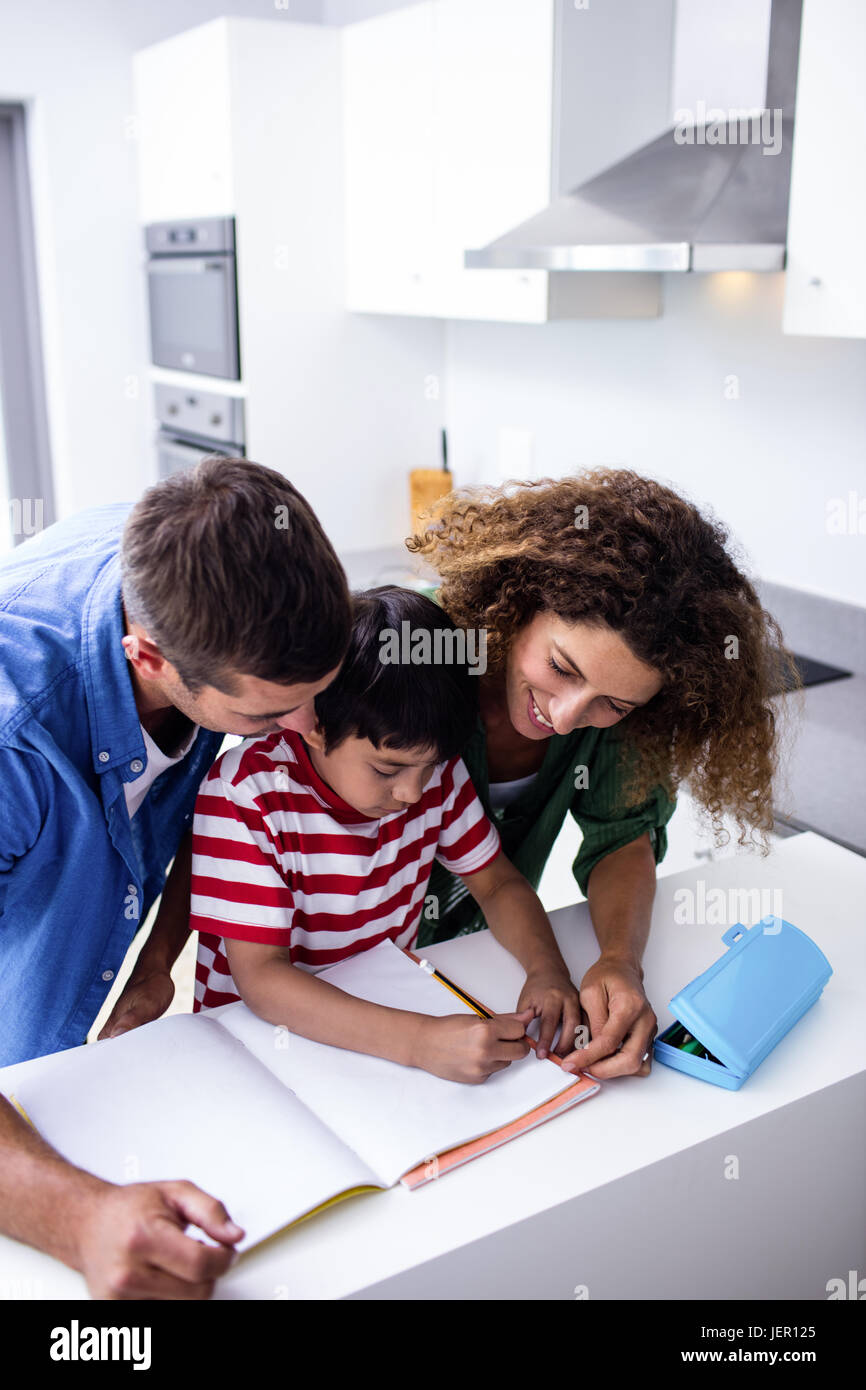 Parents helping son with homework Stock Photo - Alamy