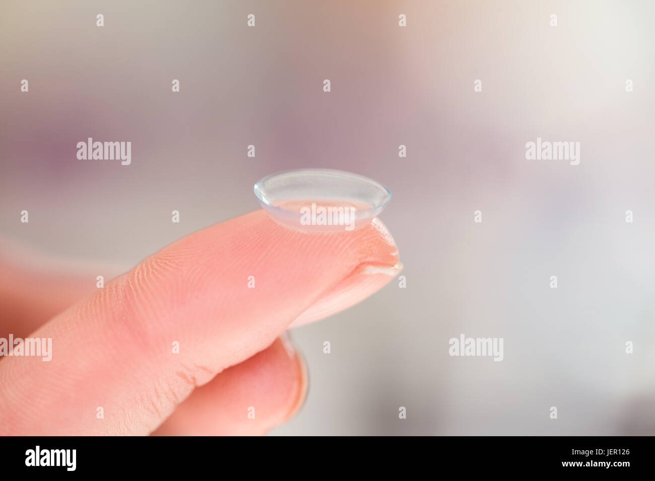 Cropped hand holding contact lens Stock Photo - Alamy