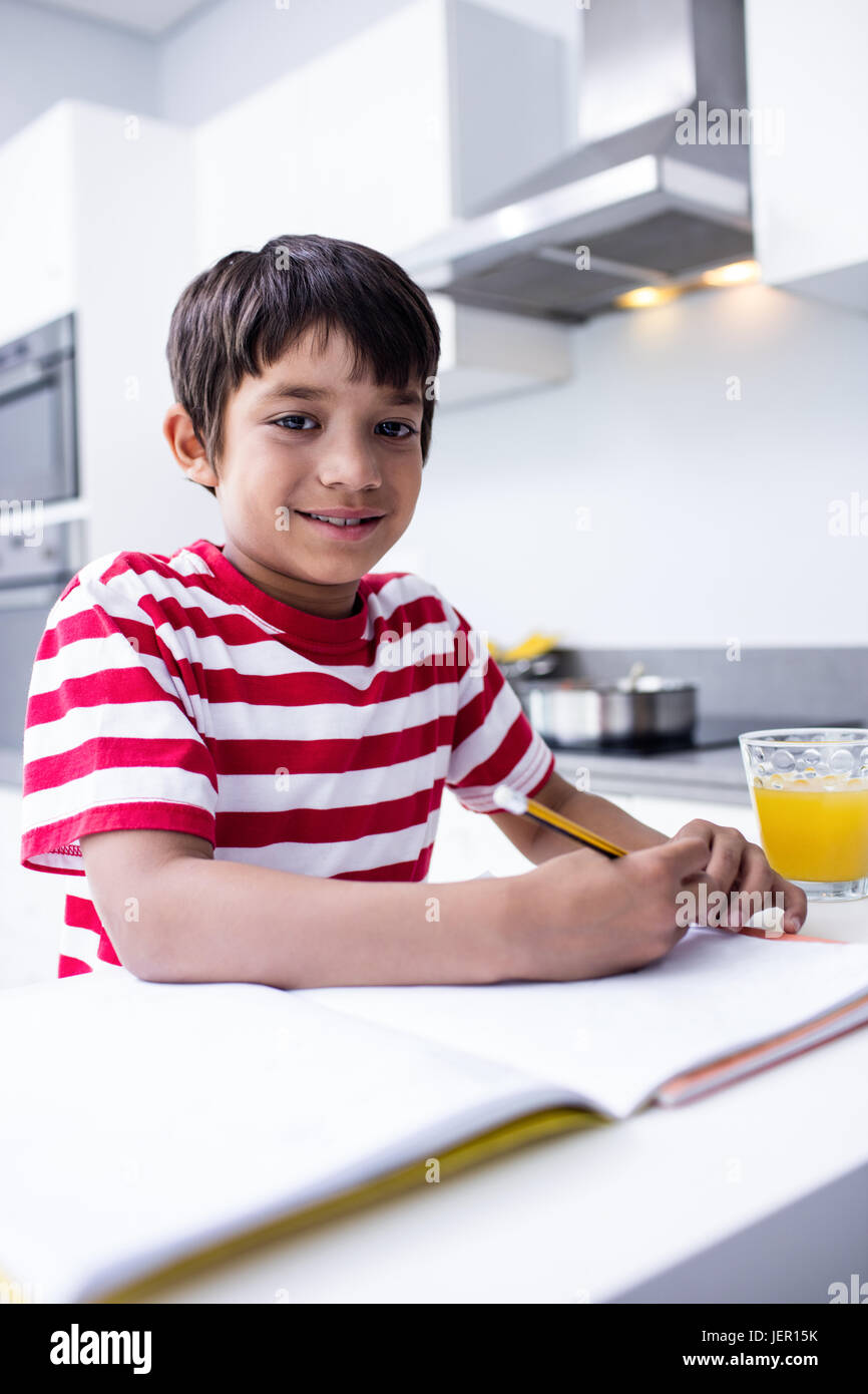 Boy doing homework in kitchen Stock Photo - Alamy