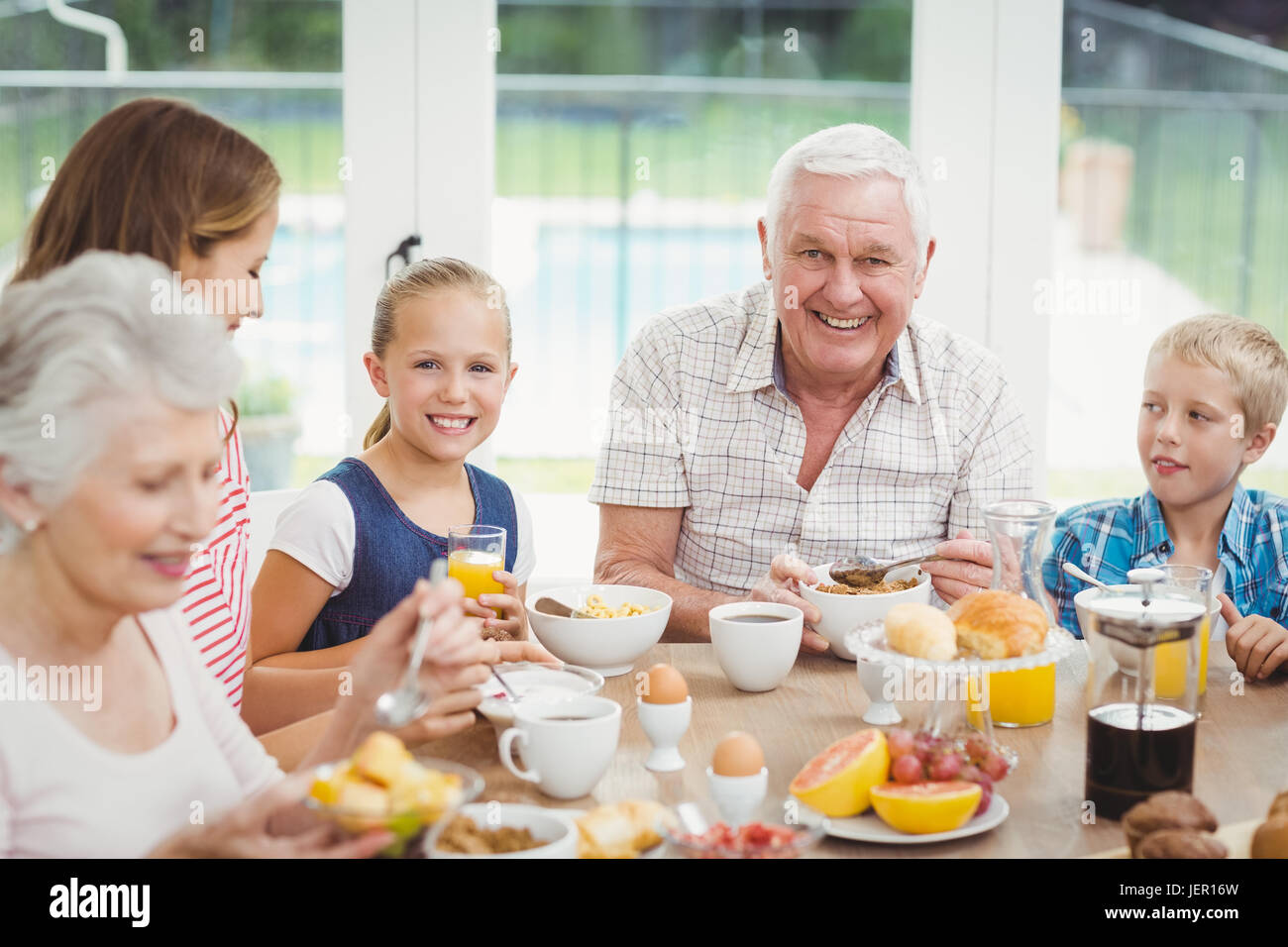 Family having breakfast at table Stock Photo - Alamy