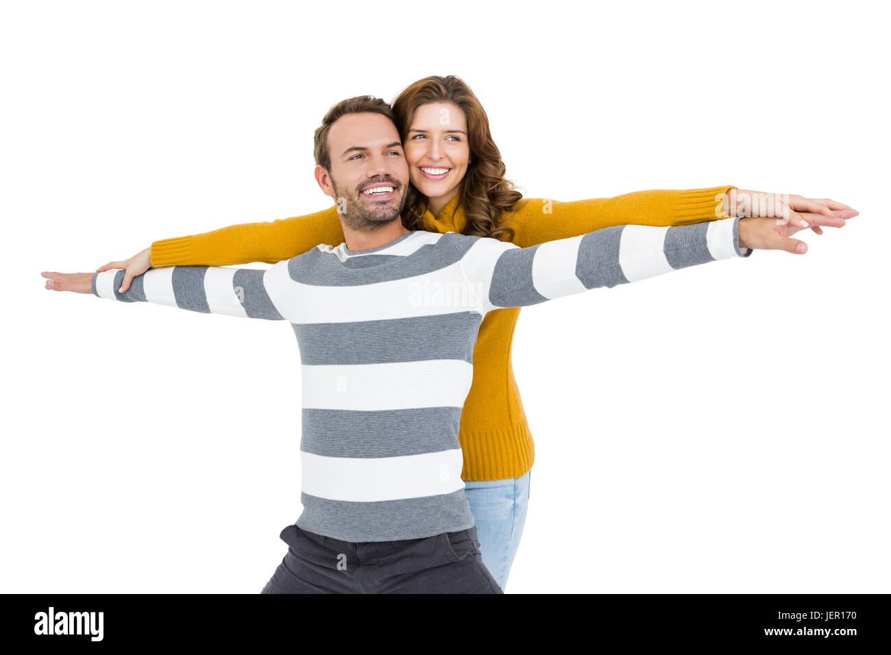 Young couple standing with arms outstretched Stock Photo - Alamy