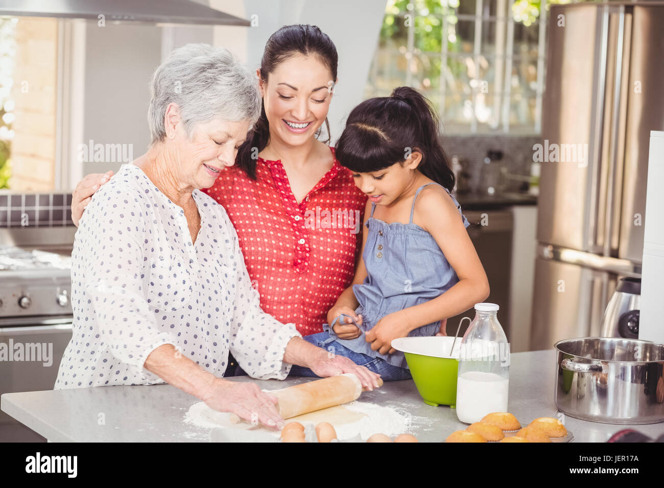 Grandmother with family making bread Stock Photo - Alamy