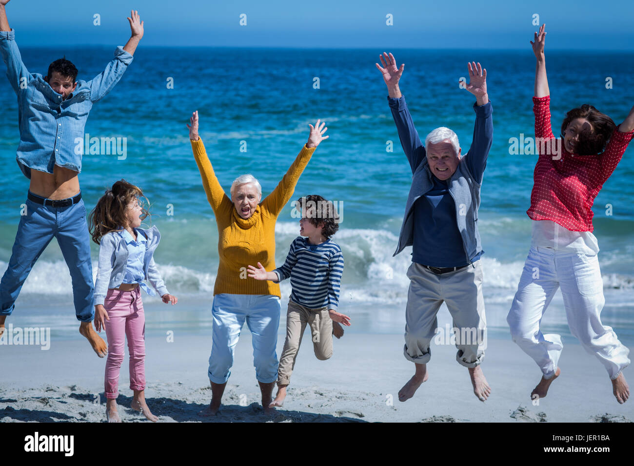 Happy smiling family jumping together Stock Photo - Alamy