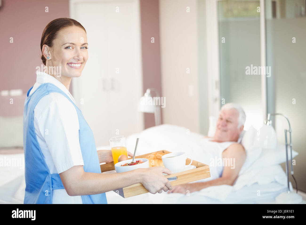 Portrait of confident nurse with tray Stock Photo - Alamy