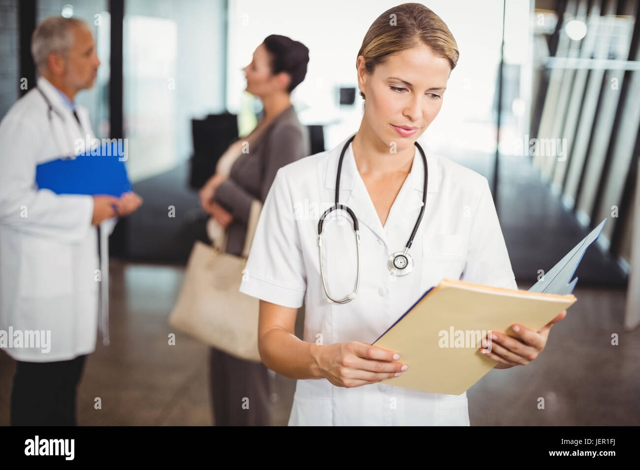 Doctor reading report hi-res stock photography and images - Alamy