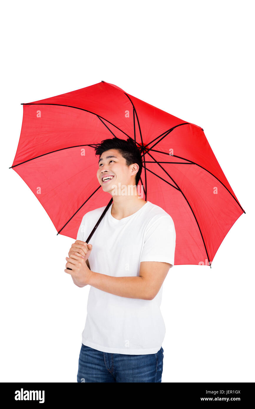 Young man holding umbrella Stock Photo - Alamy