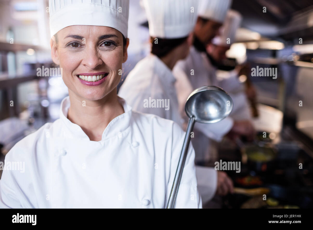 Chef holding ladle smiling hi-res stock photography and images - Alamy