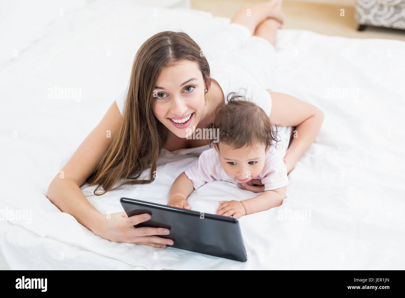 Baby girl looking tablet hi-res stock photography and images - Alamy