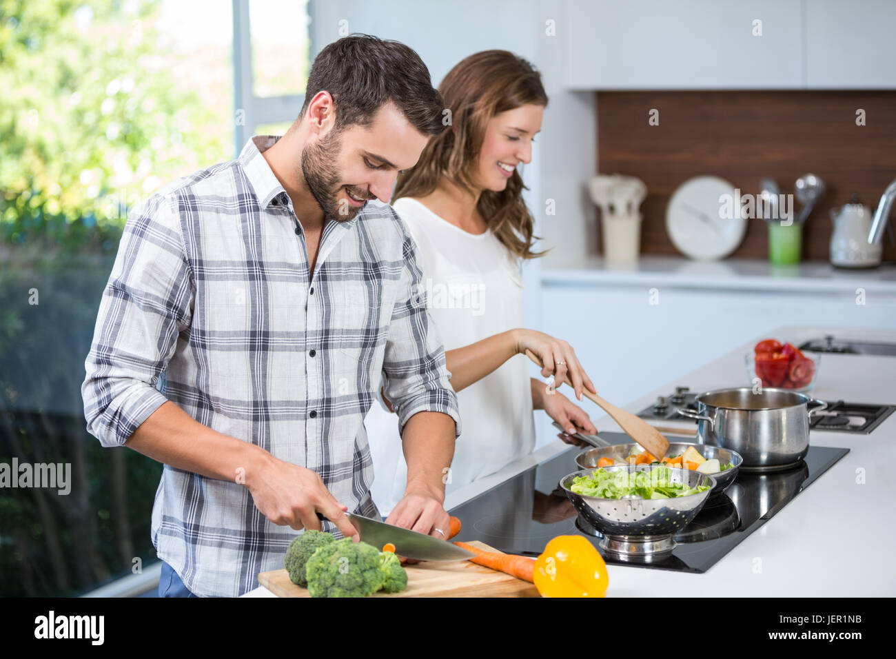 Couple preparing food at kitchen counter Stock Photo - Alamy