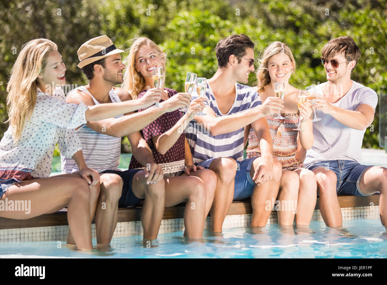 Happy friends interacting toasting glasses hi-res stock photography and ...