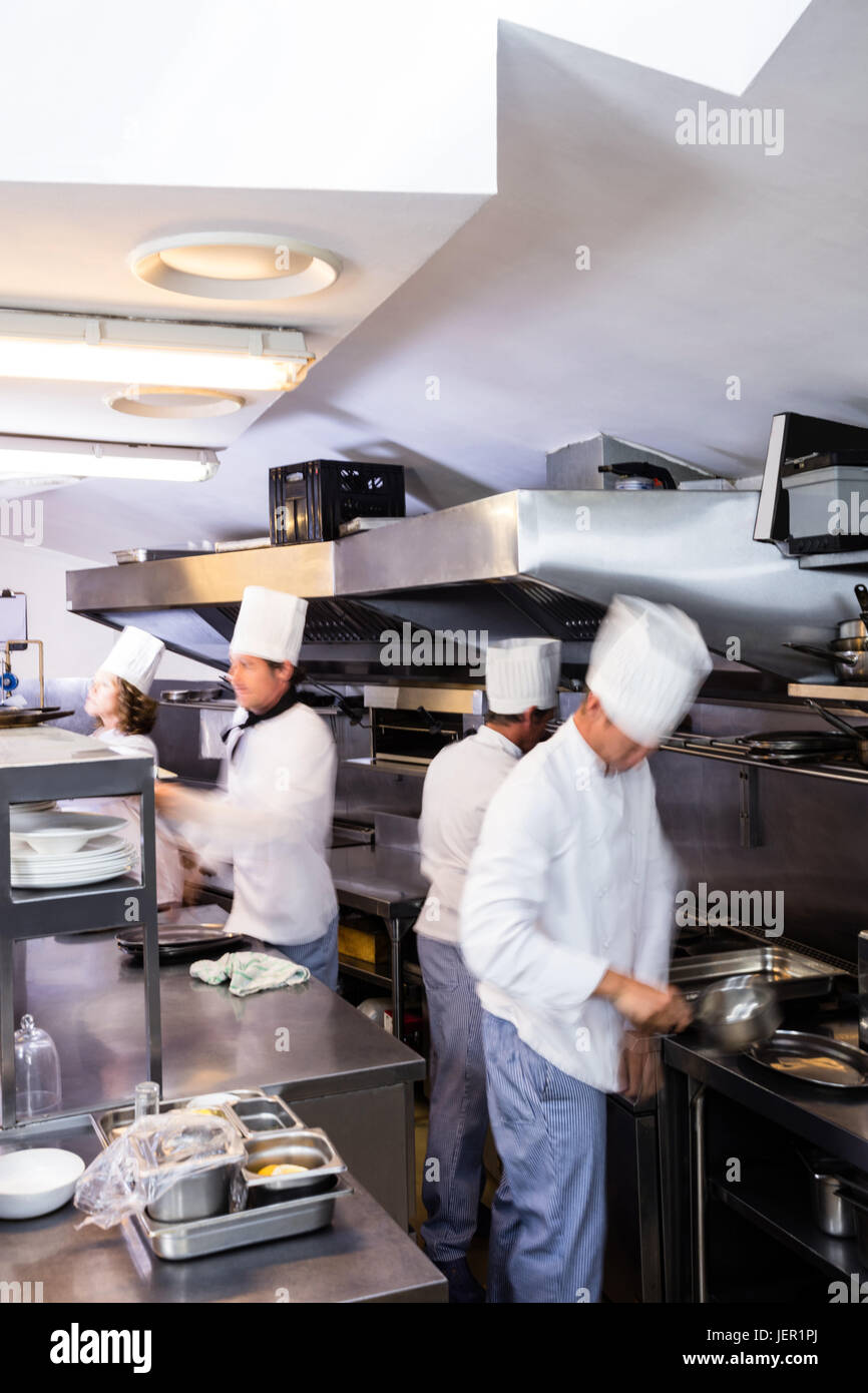 Team of chefs preparing food in the kitchen Stock Photo - Alamy