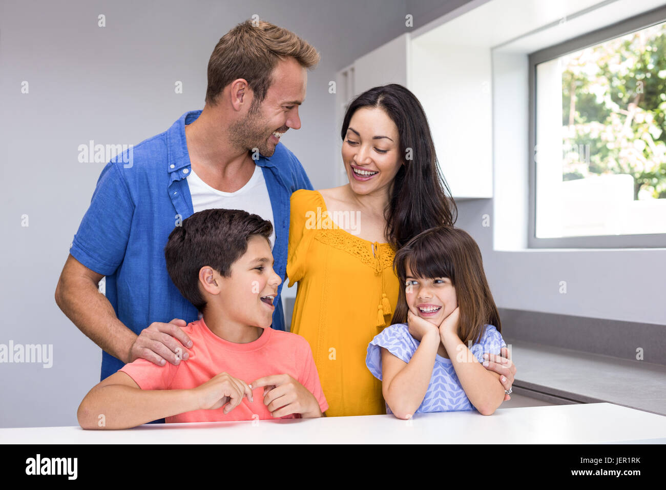 Happy family in living room Stock Photo - Alamy