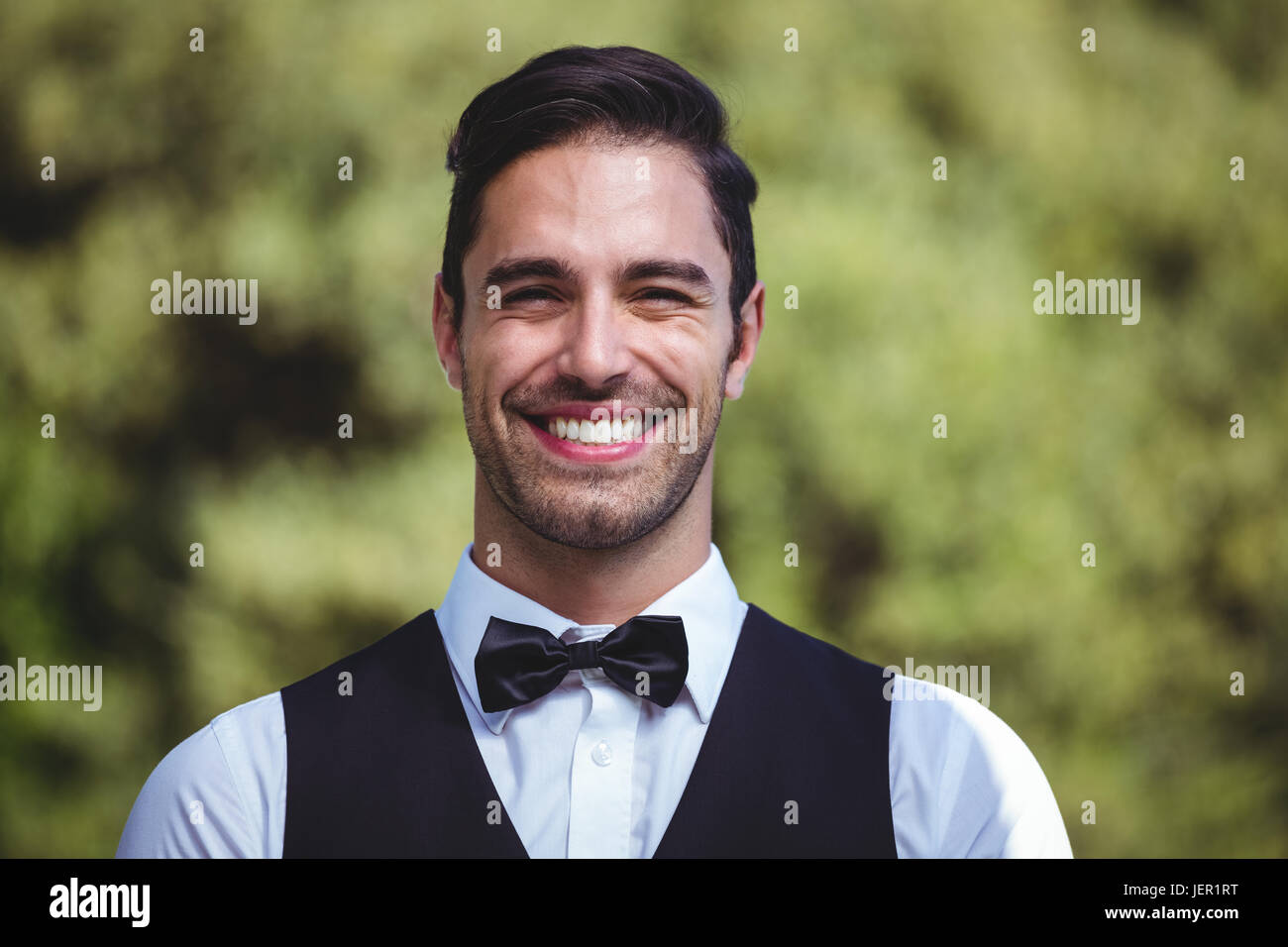 Handsome waiter smiling at camera Stock Photo - Alamy