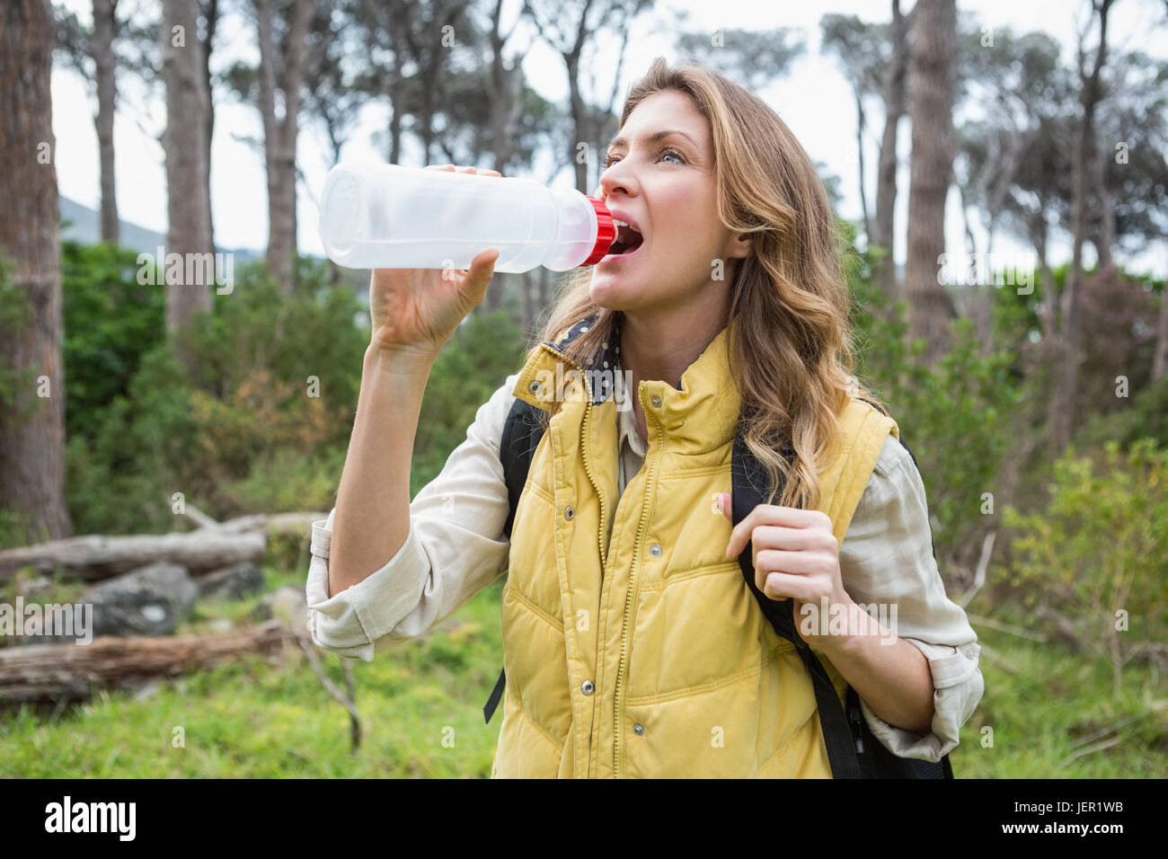 Woman drinking water while doing a break Stock Photo - Alamy