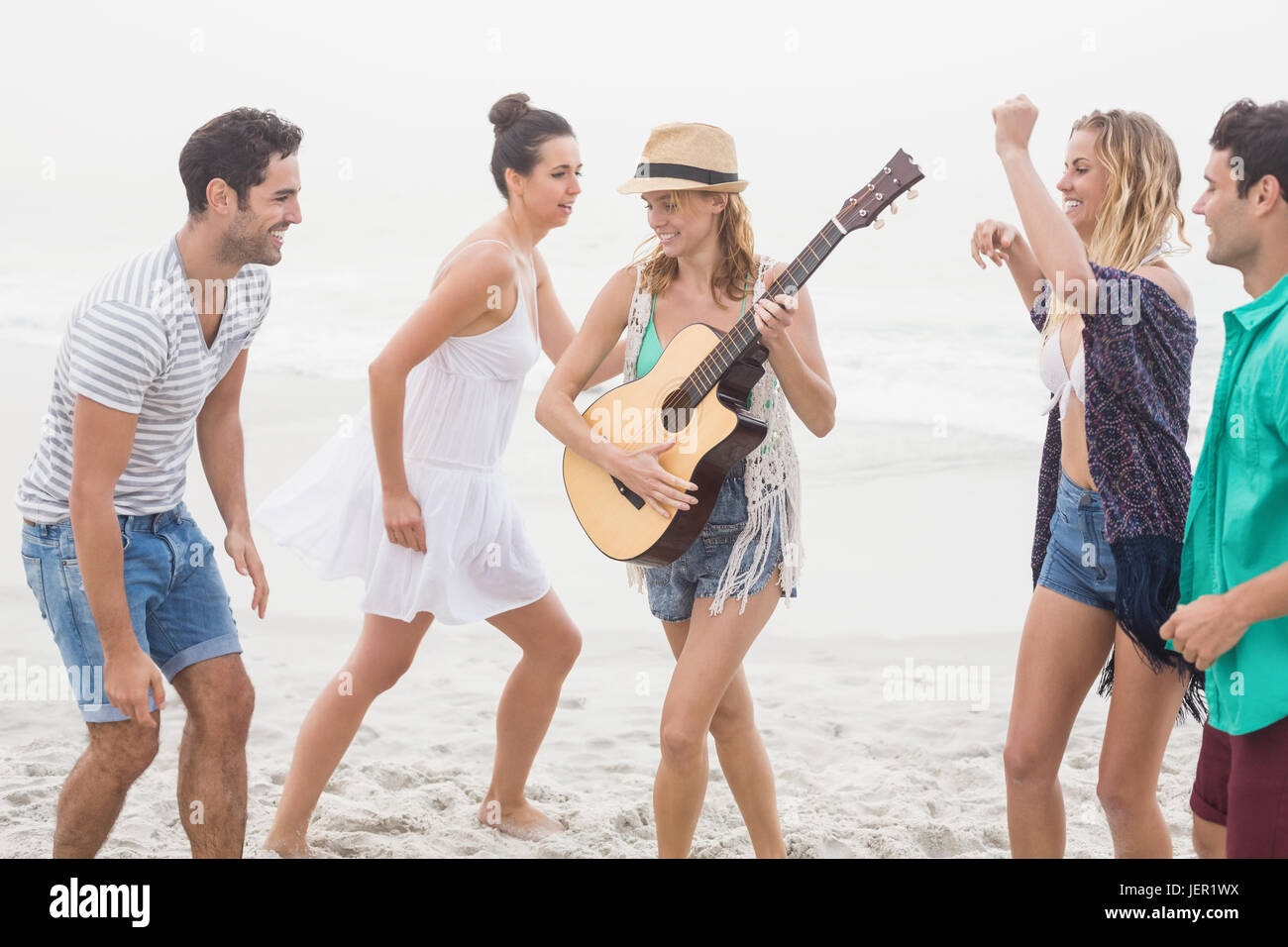 Group of friends playing guitar and dancing Stock Photo - Alamy