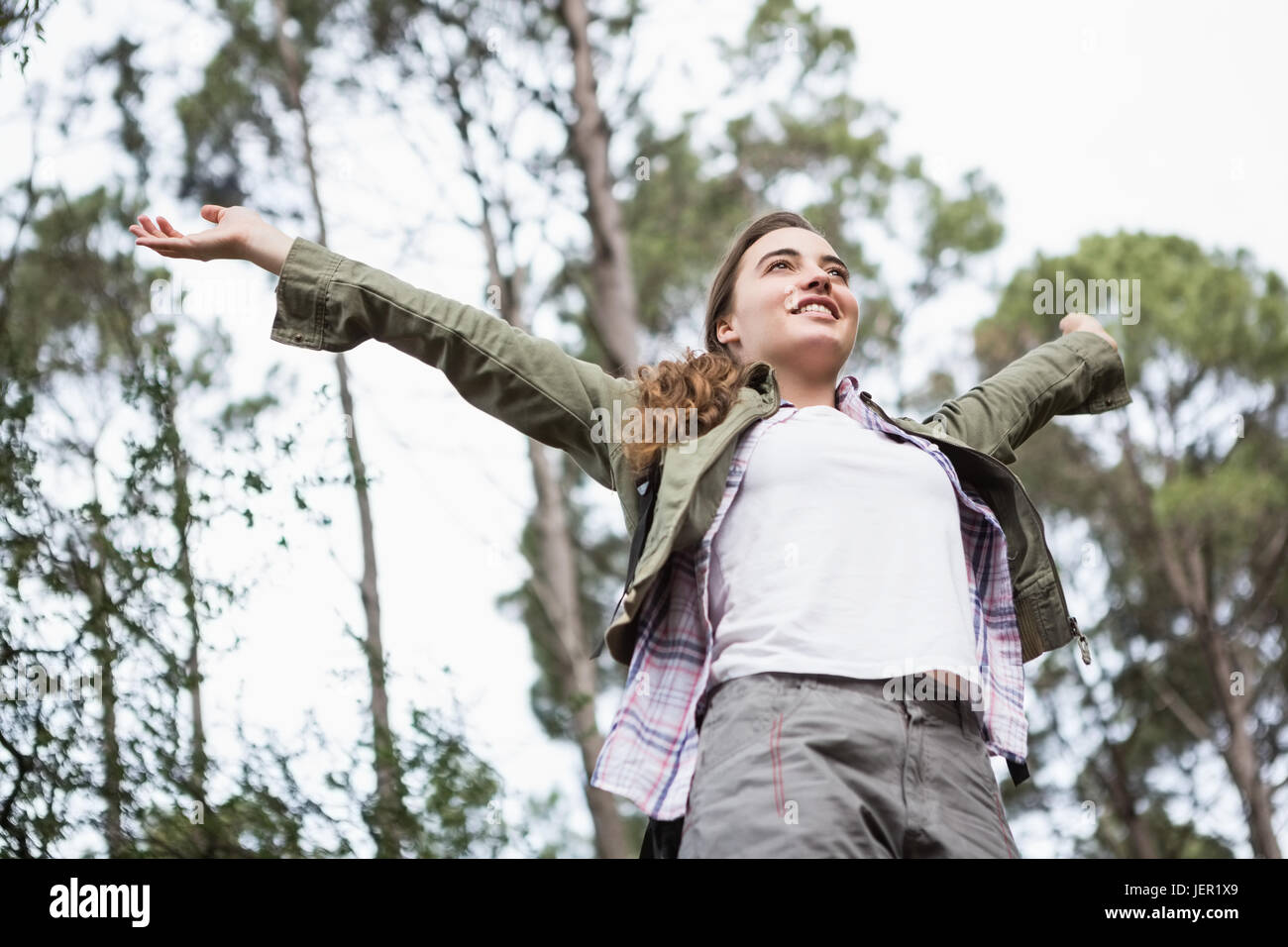 Smiling woman with arms up Stock Photo - Alamy
