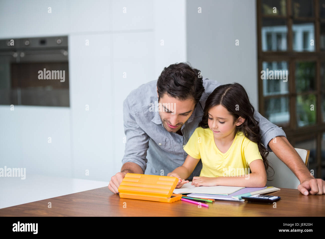 Father assisting daughter with homework Stock Photo - Alamy