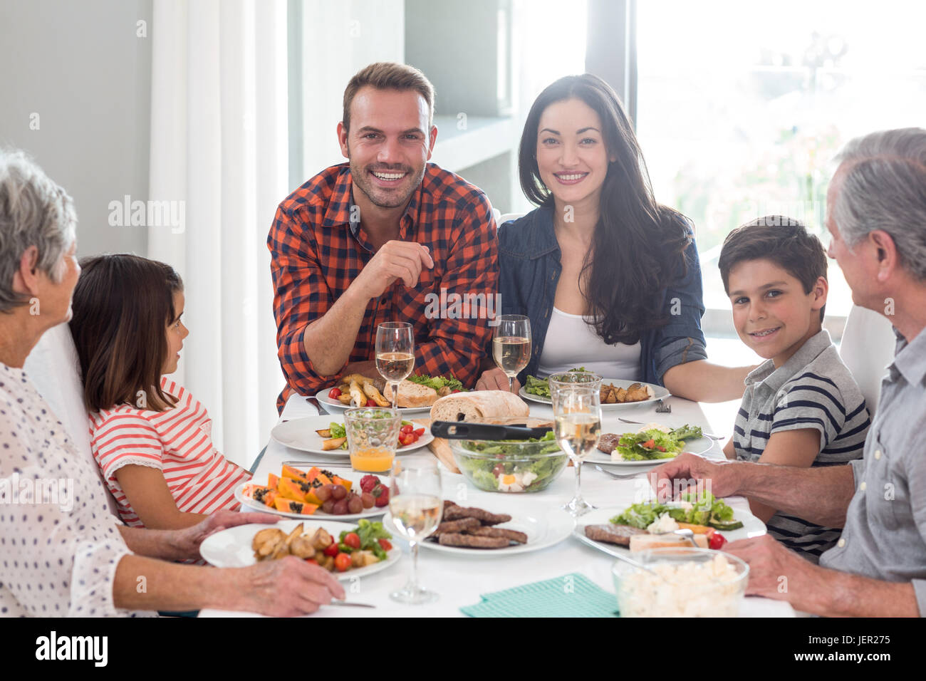 Family together having meal Stock Photo - Alamy
