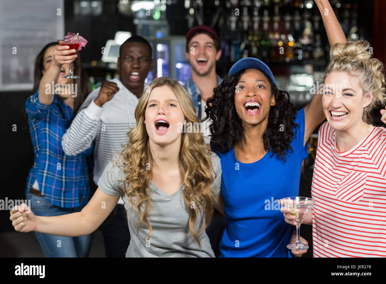 Happy friends watching sport Stock Photo - Alamy