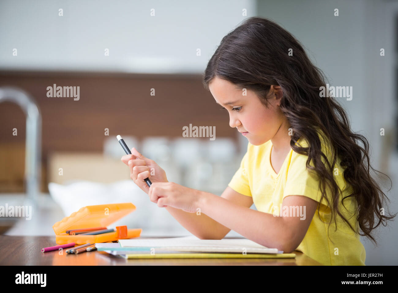 Girl holding pen hi-res stock photography and images - Alamy