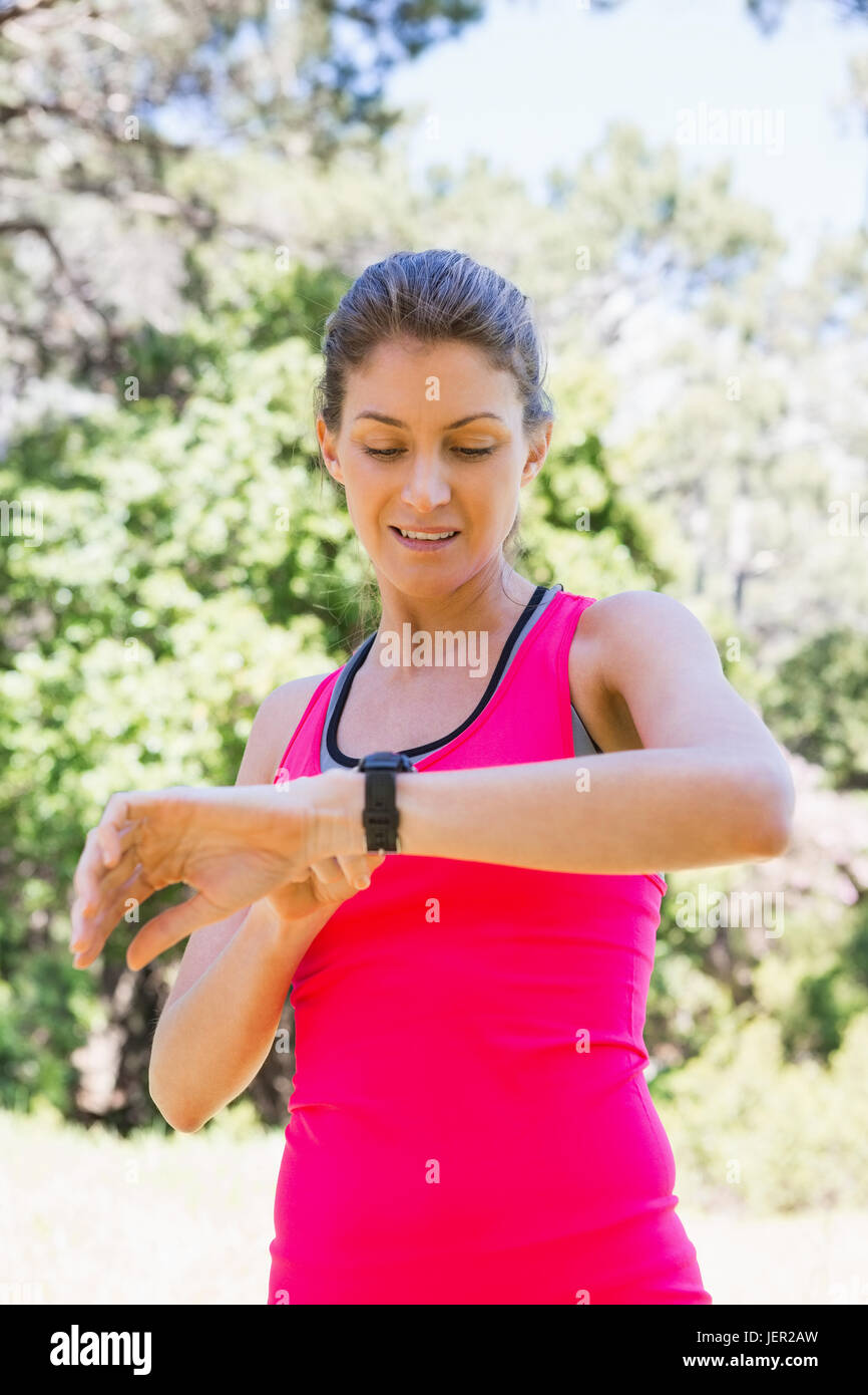 Woman looking at her watch Stock Photo - Alamy