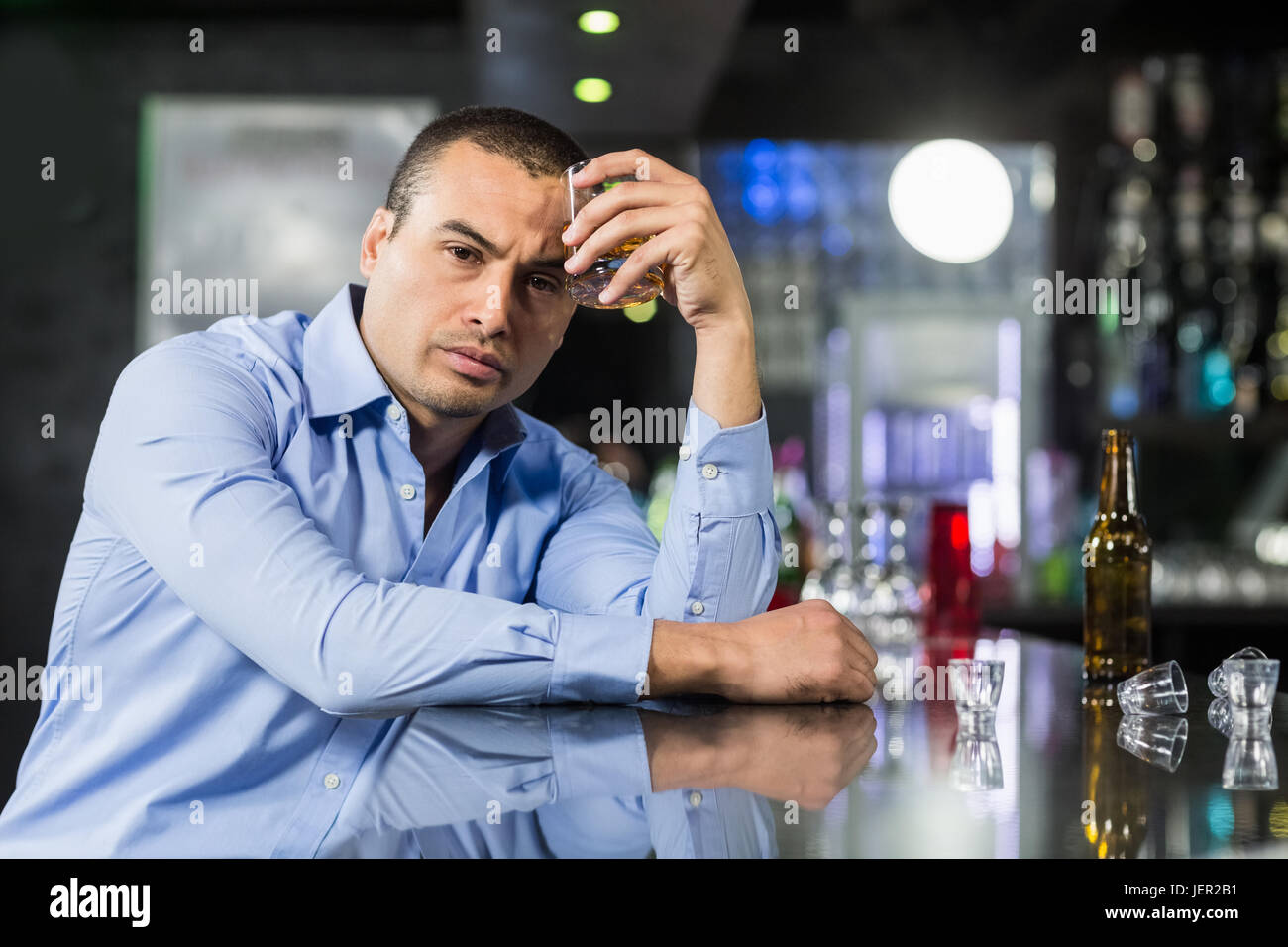 Depressed man drinking alcohol Stock Photo - Alamy