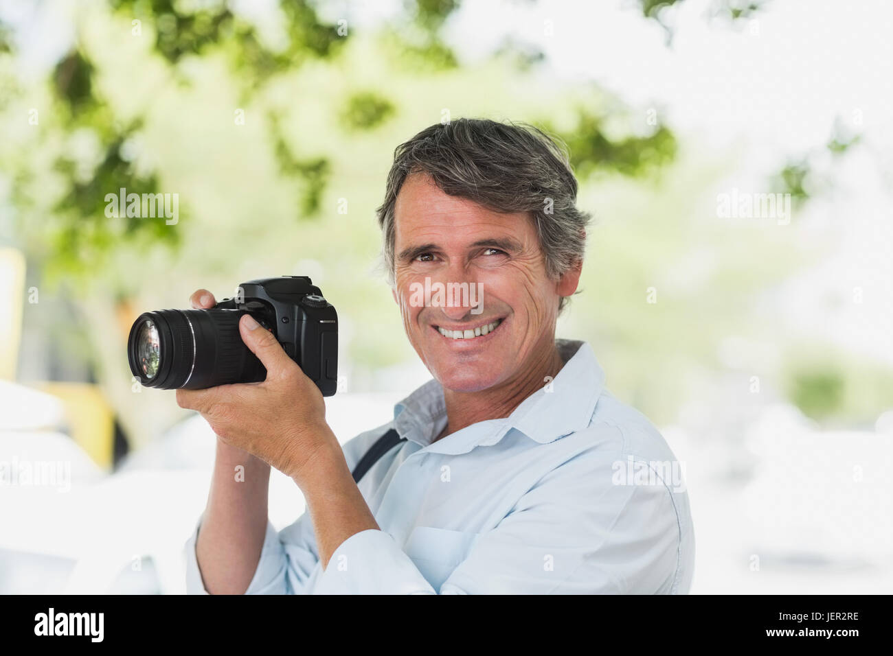 Portrait of man using camera Stock Photo - Alamy