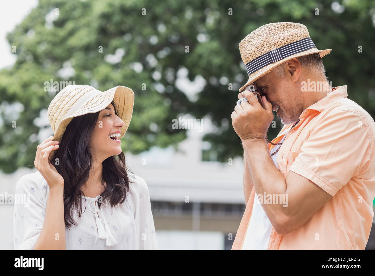 Man photographing woman Stock Photo - Alamy